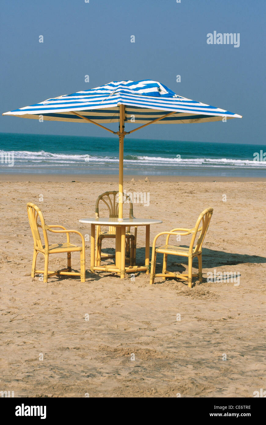 MMN 85988 : three empty beach cane chairs table blue white stripes ...
