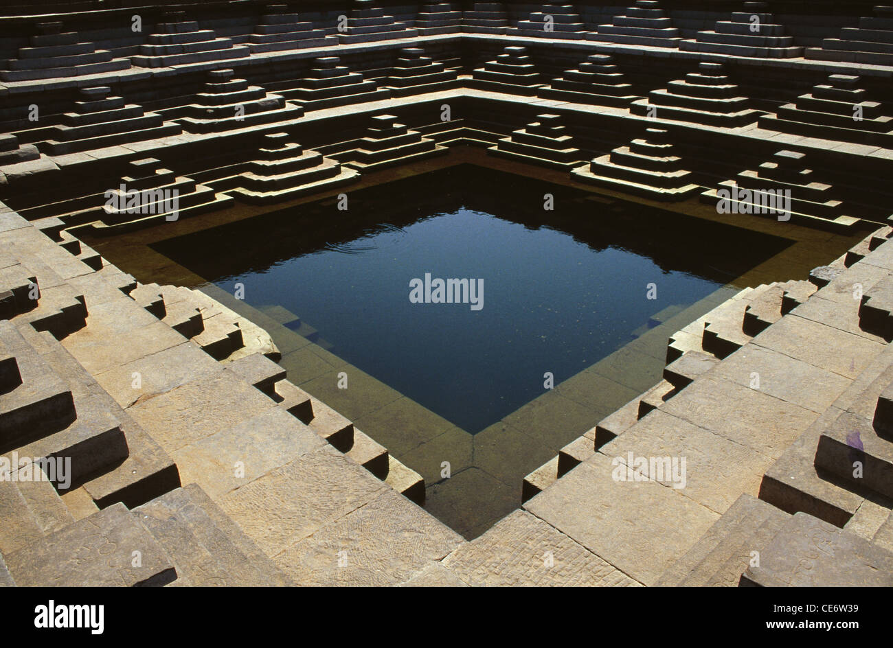 Pushkarni stepped tank hampi hospet karnataka india Stock Photo - Alamy