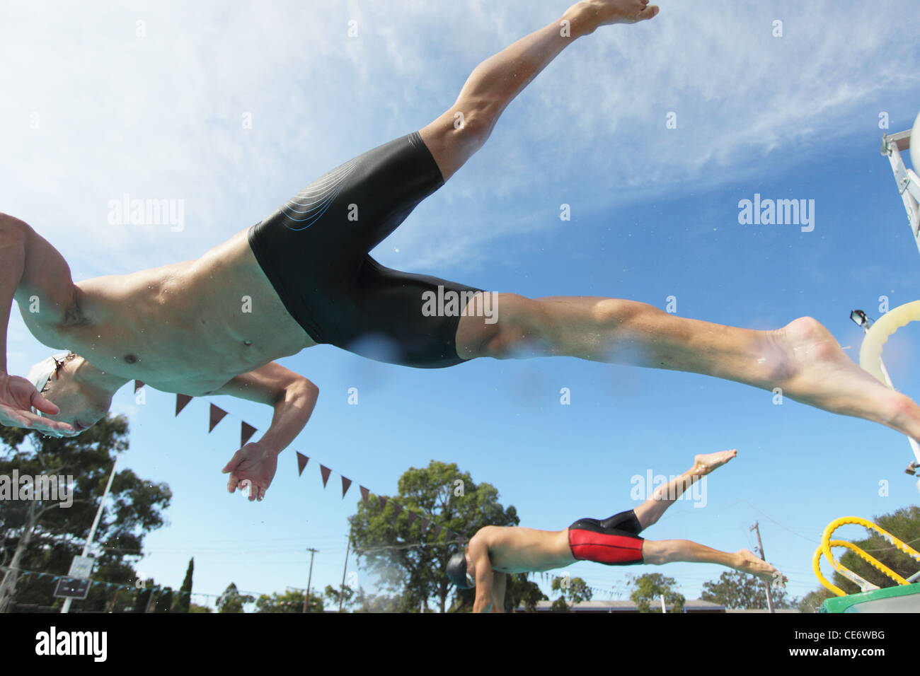 Swimmers Diving into Pool Stock Photo - Alamy