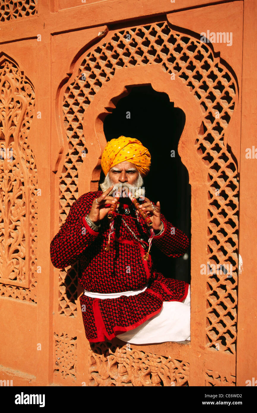 Indian rajasthani folk musician playing wind musical instrument flute ...