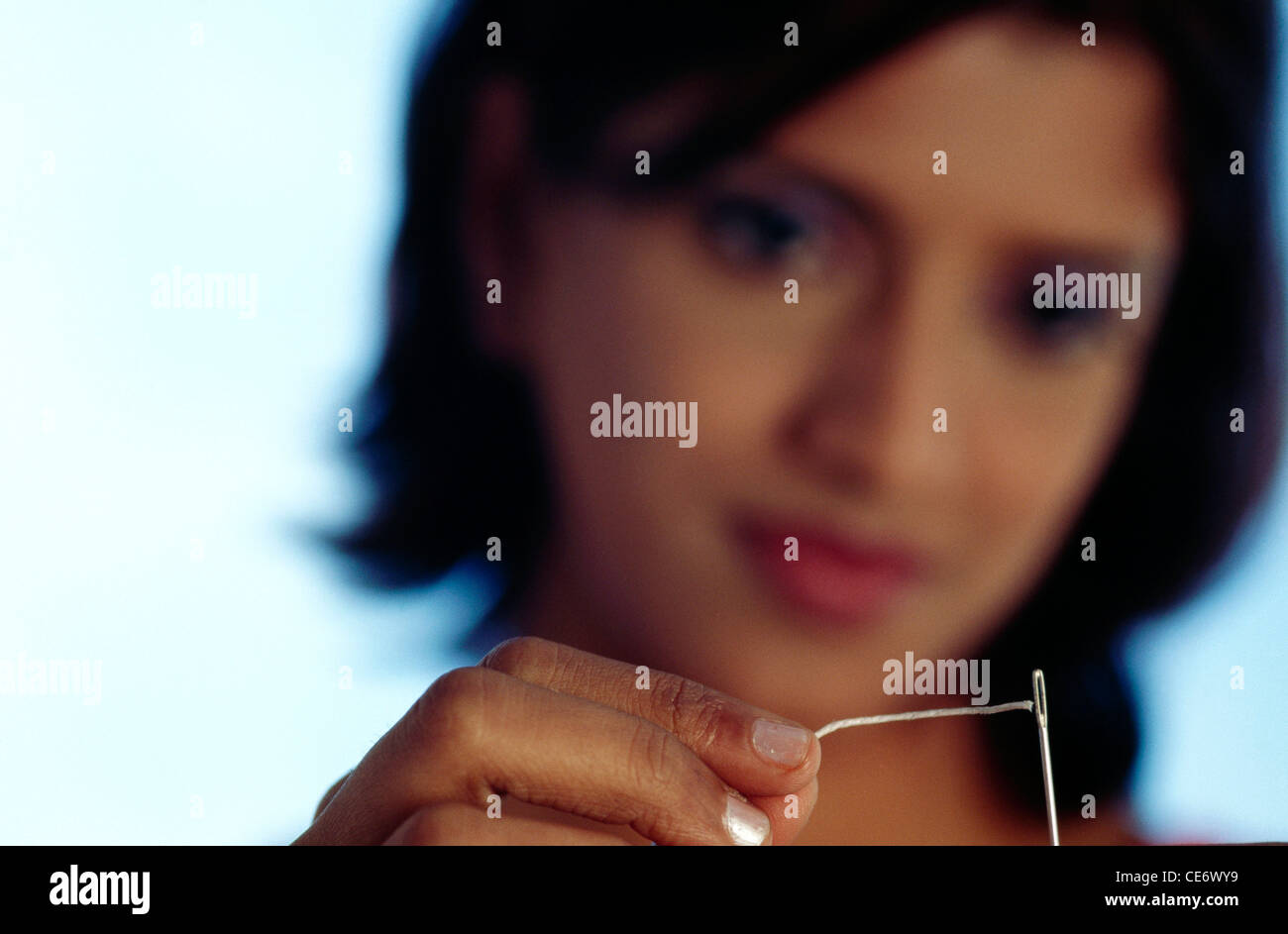 Woman threading a needle hi-res stock photography and images - Alamy