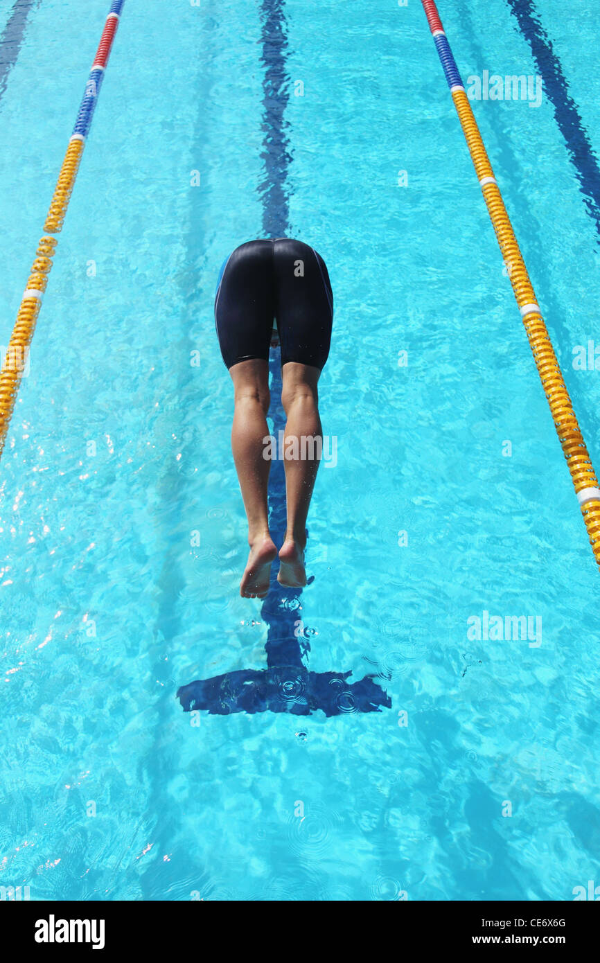 Young Woman Diving into Swimming Pool Stock Photo - Alamy