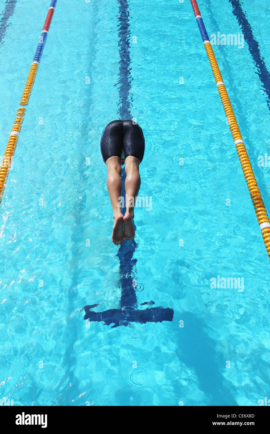 Young Woman Diving into Swimming Pool Stock Photo - Alamy