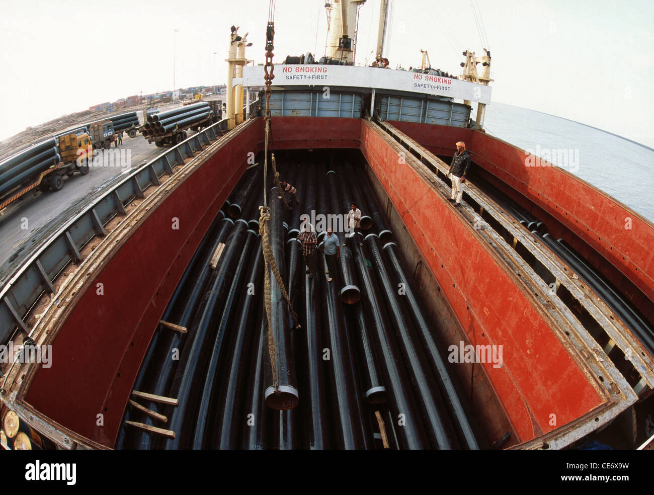 Steel pipes being loaded in ship for export from kandla port gujarat ...