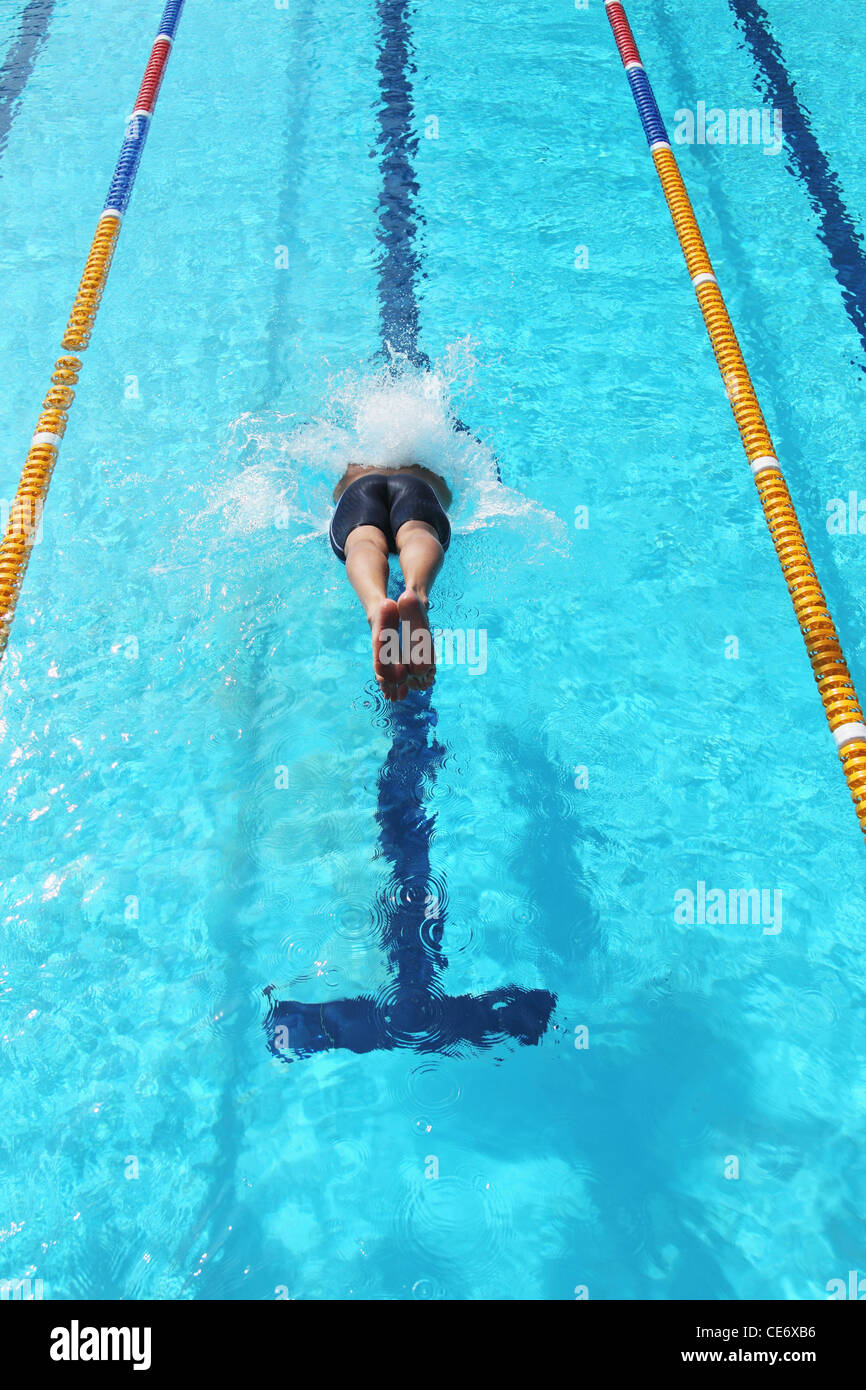 Young Woman Diving into Swimming Pool Stock Photo - Alamy