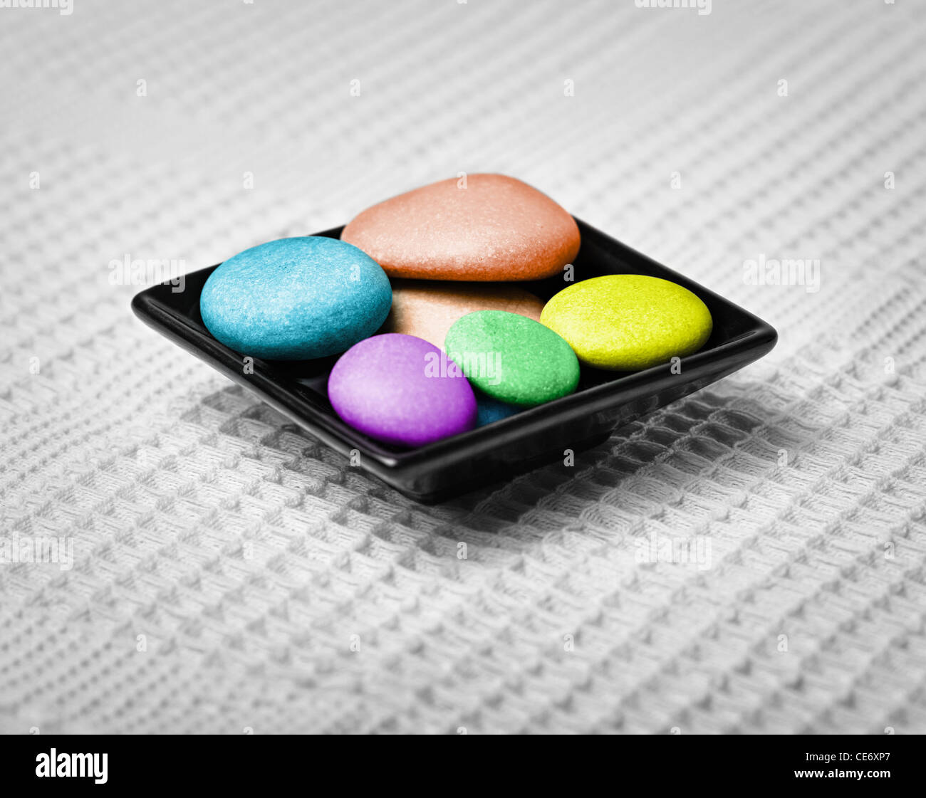 Colored pebbles in a small bowl - Spa Stock Photo - Alamy