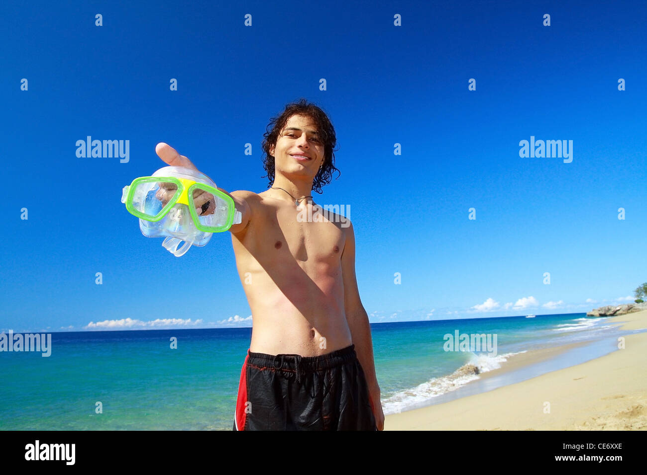 Man with swimming mask in hand on beach Stock Photo - Alamy
