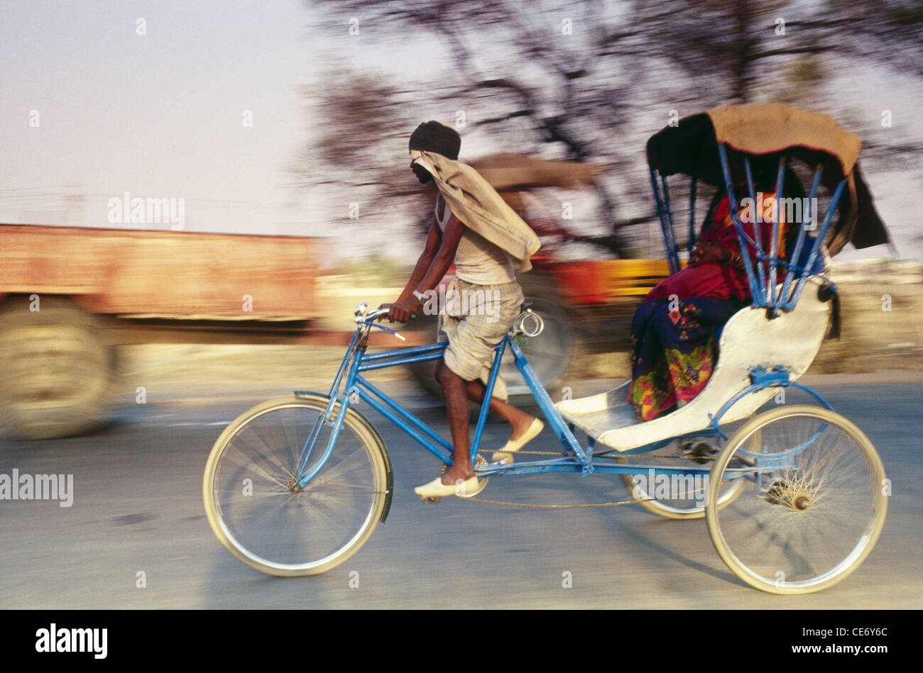 Indian rickshaw ; man pedaling driving hand rickshaw tricycle ; India ...