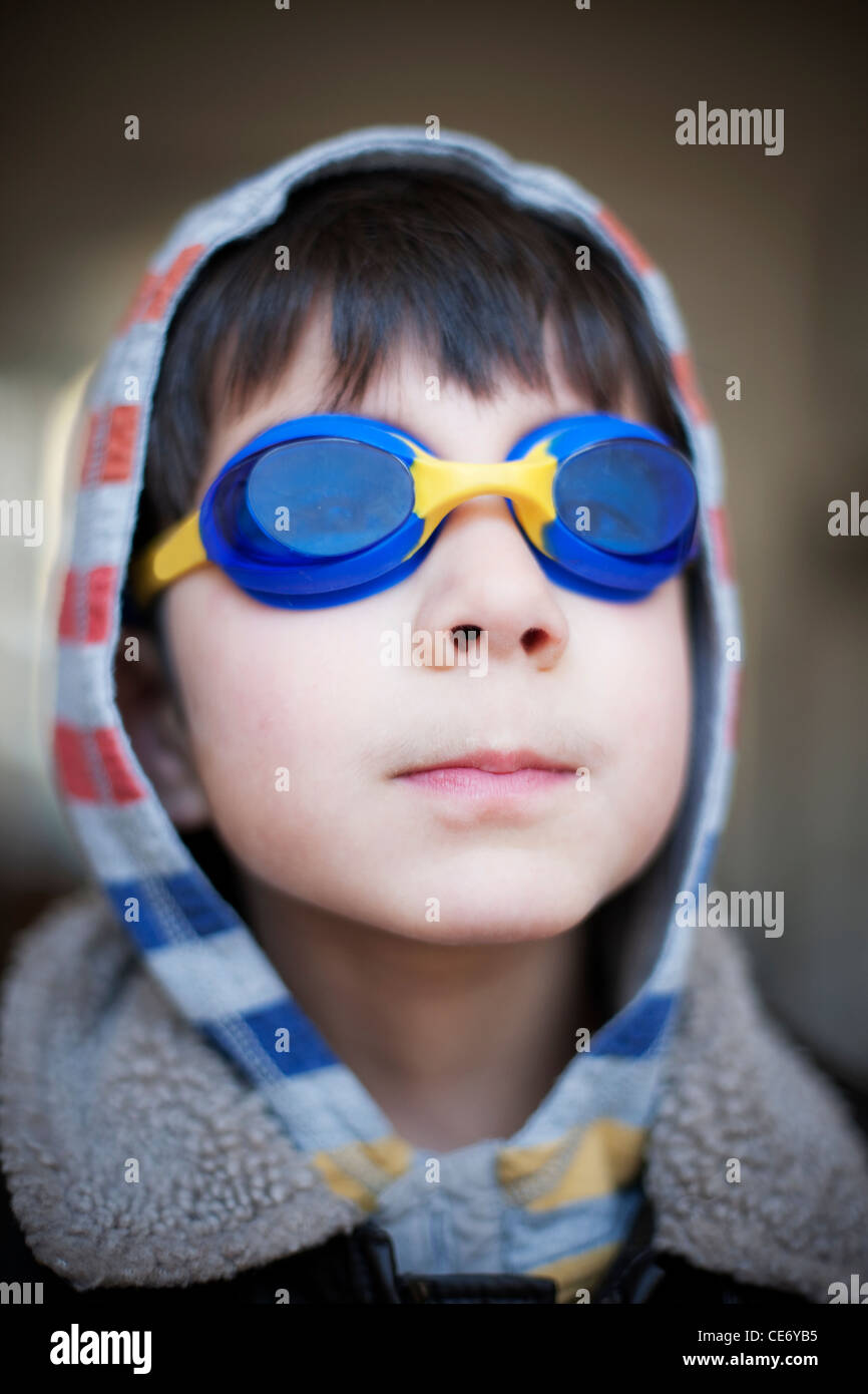 Boy wearing blue swimming goggles and hood Stock Photo - Alamy