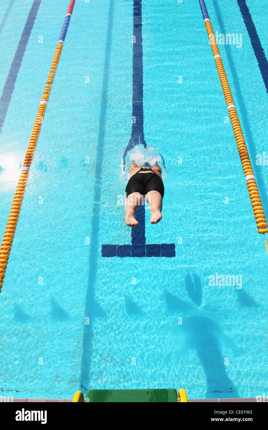 Young Woman Diving into Swimming Pool Stock Photo - Alamy