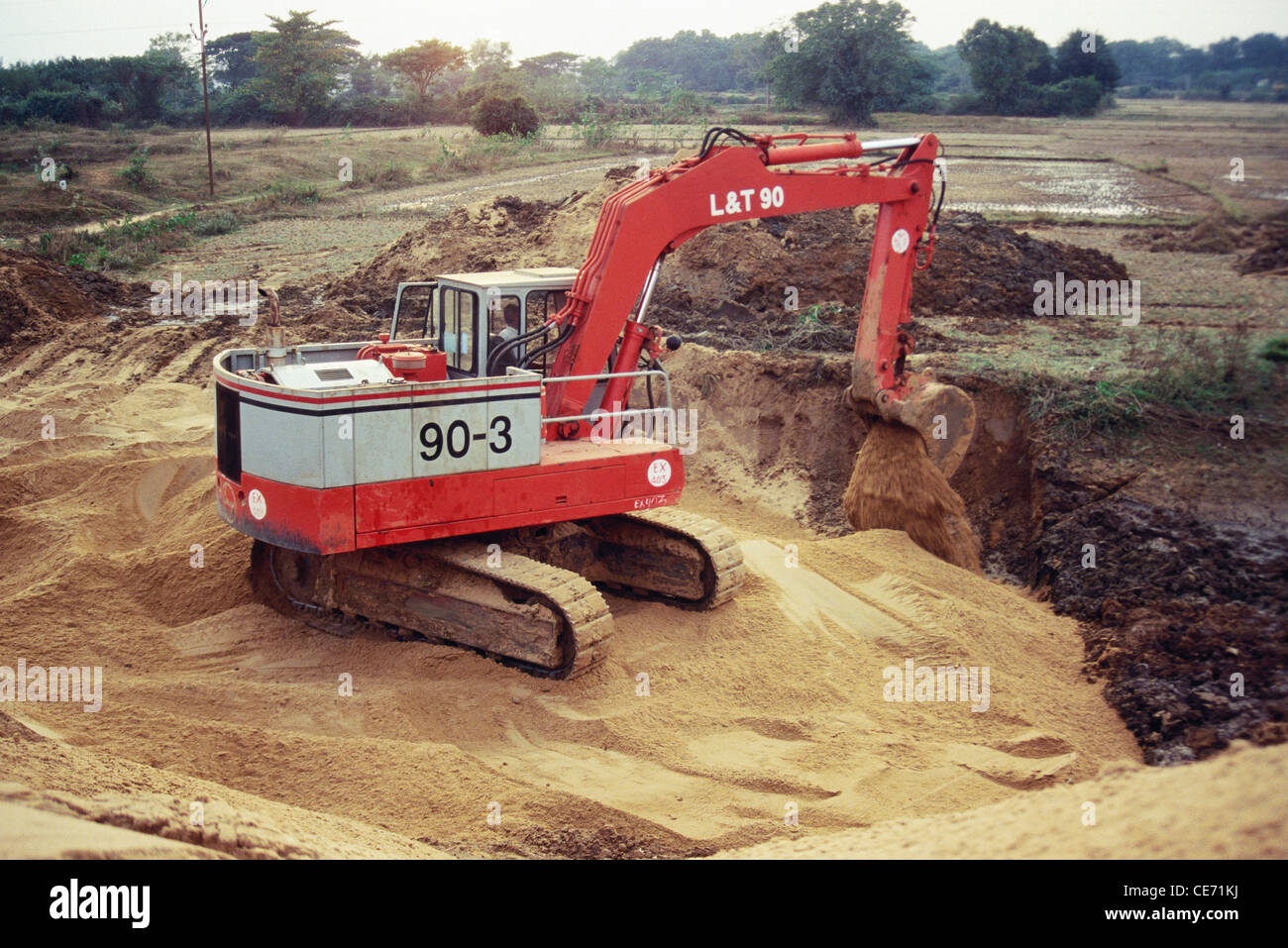 Excavator machine working ; heavy construction equipment ; pouring sand ...