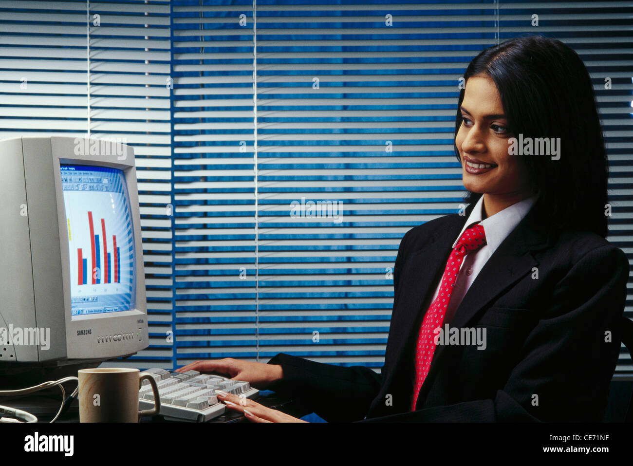 RHS 84128 : women executive black coat red tie working on computer ...