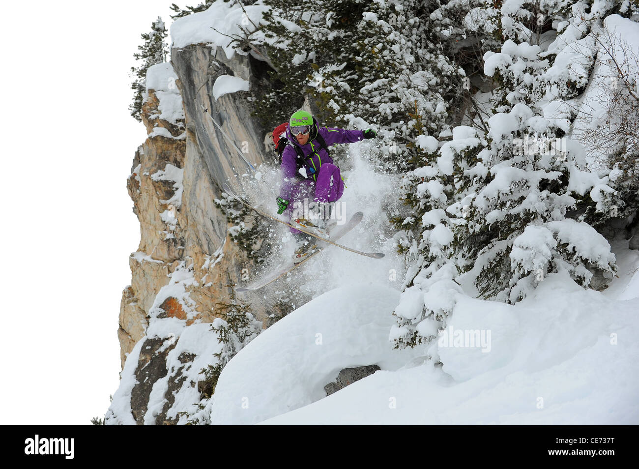 A skier jumps off rocks off piste in the ski resort of Courchevel in ...