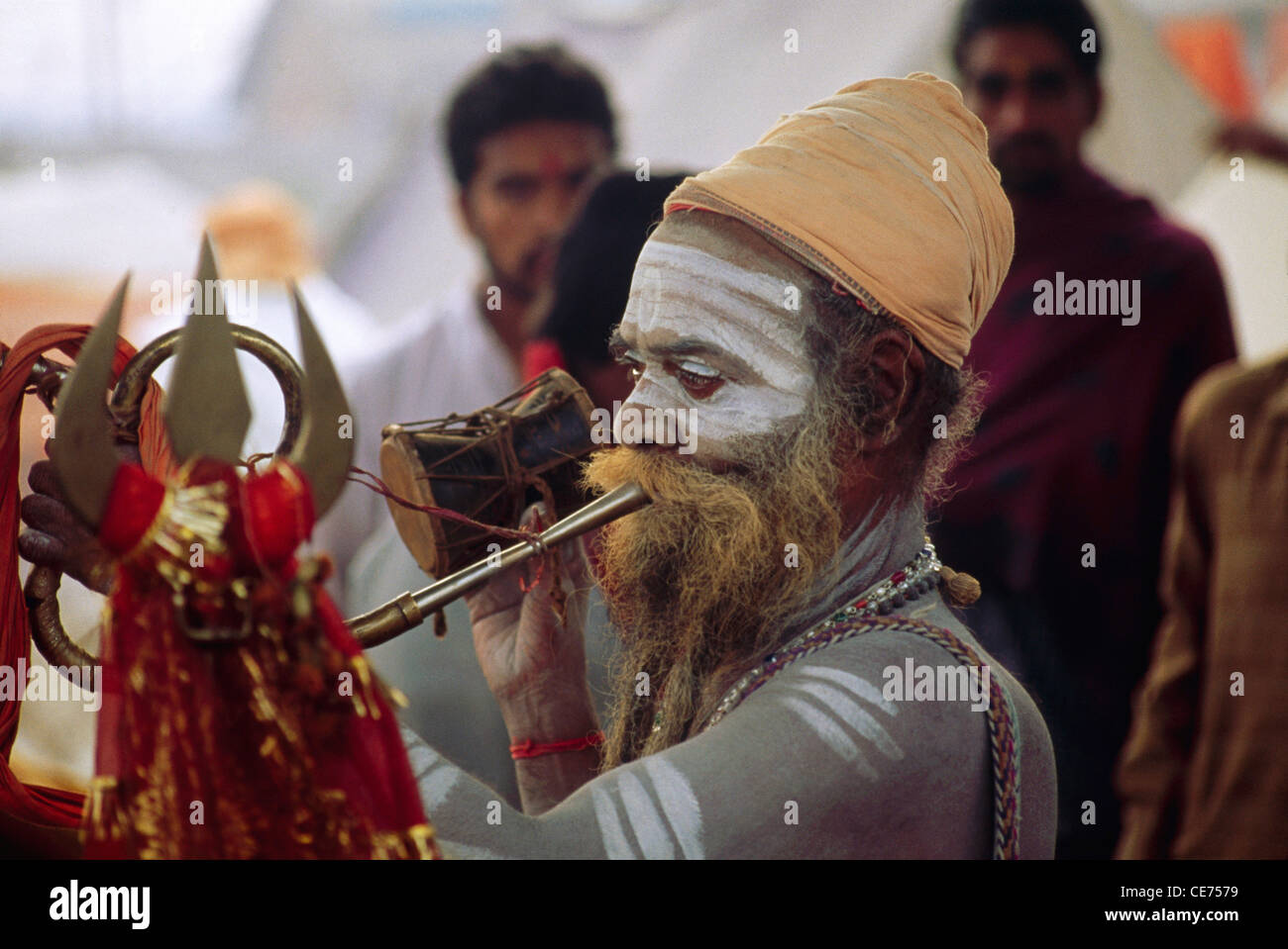 SOA 82937 : ash smeared indian sadhu playing musical instrument Kumbh ...