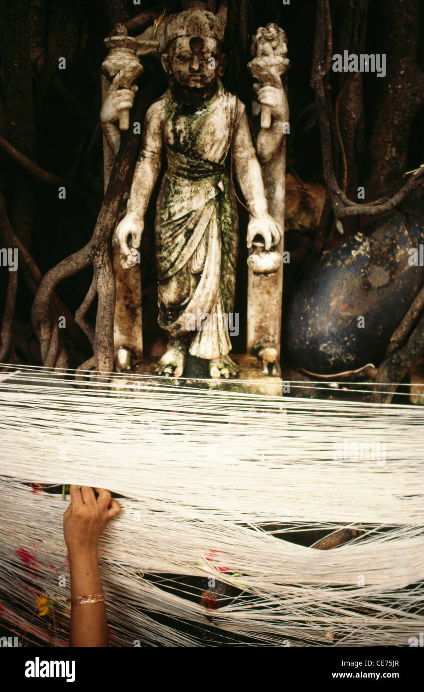 RVA 83072 : women tying sacred thread around tree with statue of indian ...
