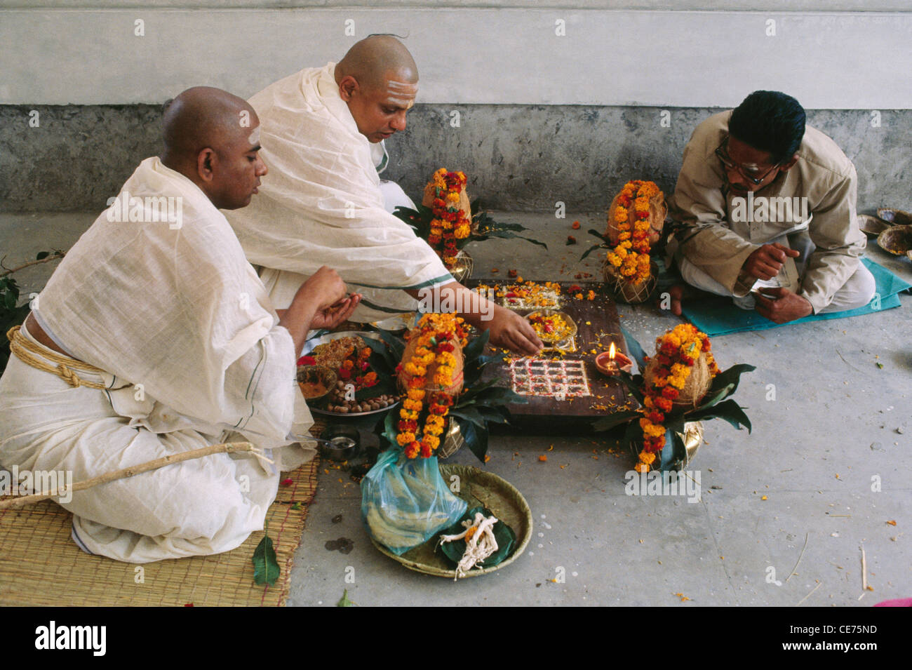 RVA 83087 : three indian hindu sanyasi priests performing pooja puja ...