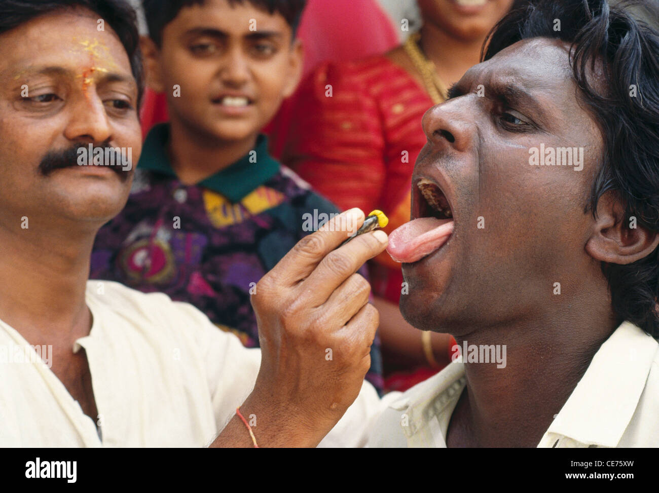 Indian fish cure treatment ; gulping fish with medicine ; India ; Asia ...