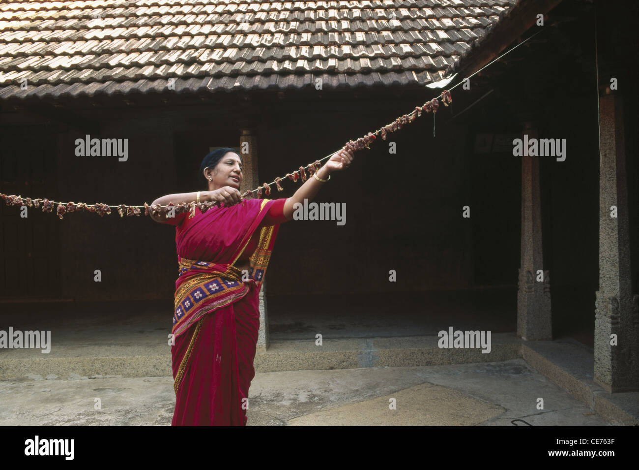 Indian woman drying meat in house courtyard Tamil Nadu India Asia ...