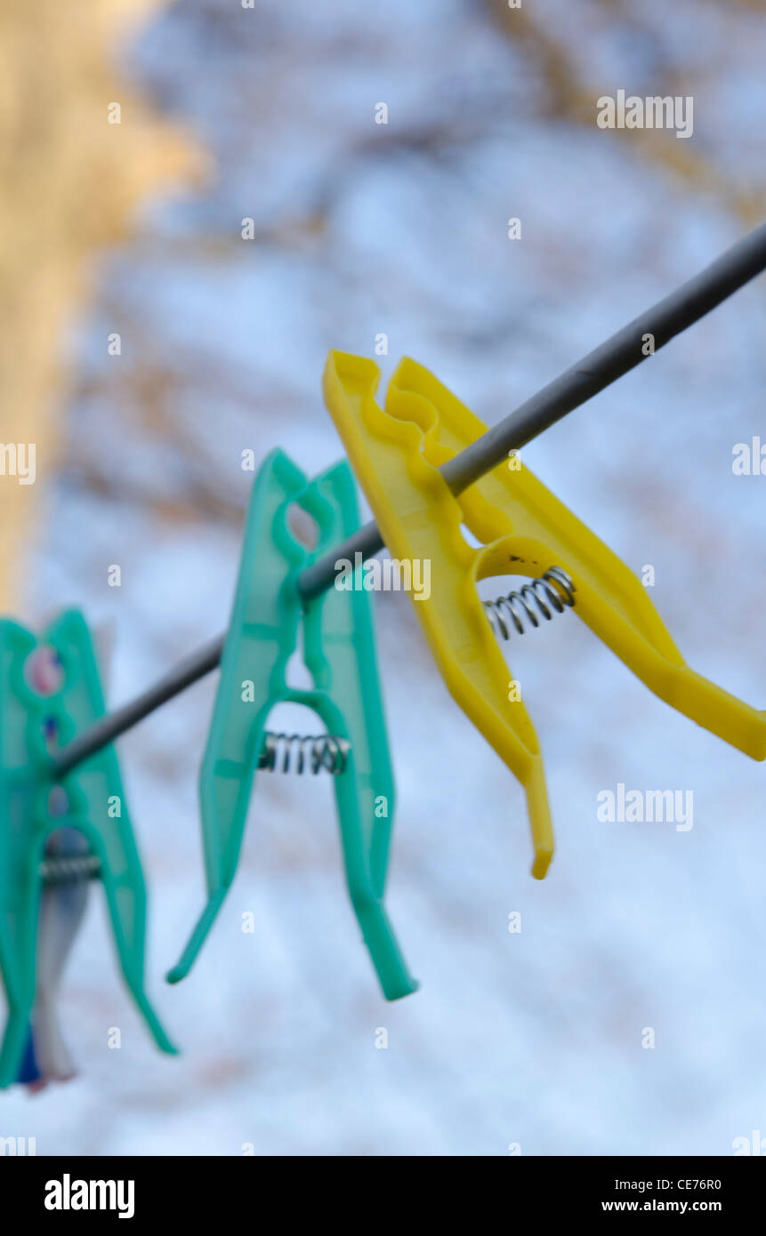 One Yellow and Two Green Washing Line Pegs Stock Photo - Alamy