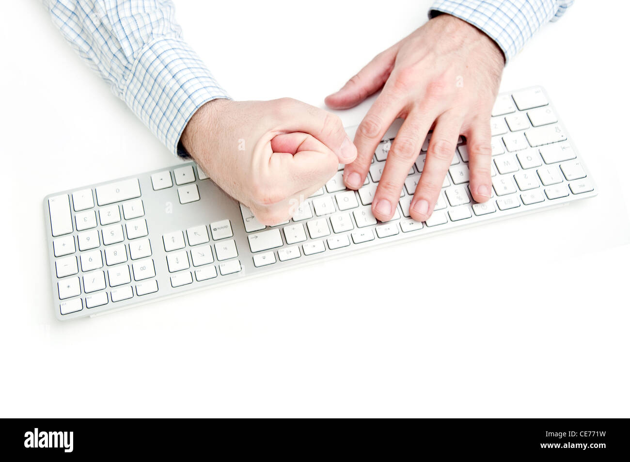 Angry businessman hits the computer keyboard on a white desk top Stock ...