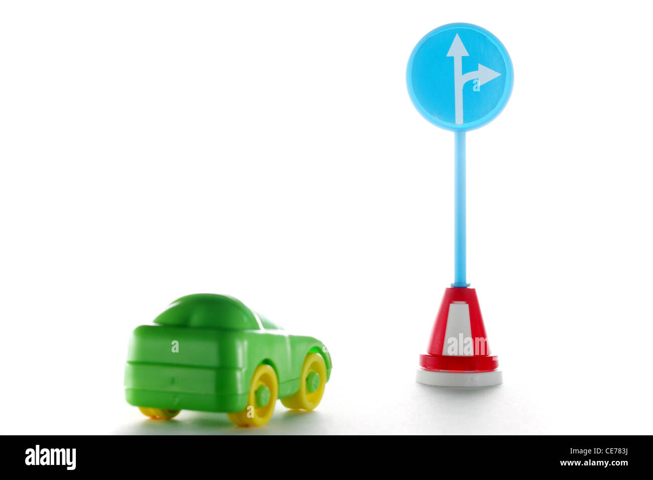 Car behind directions road sign on a white background Stock Photo - Alamy