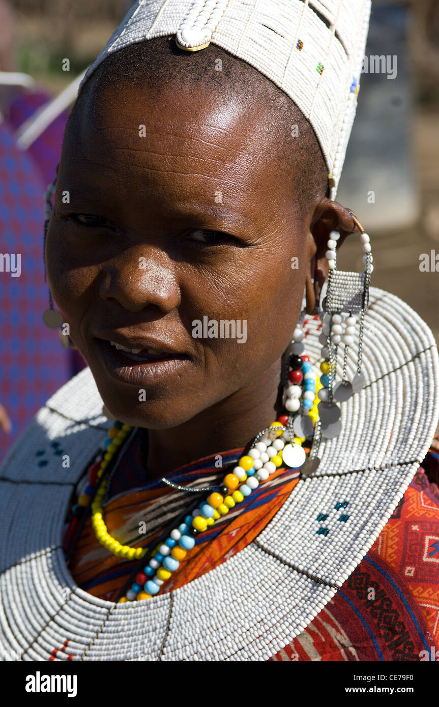 A Masai woman in Tanzania with the traditional shaved head and split ...