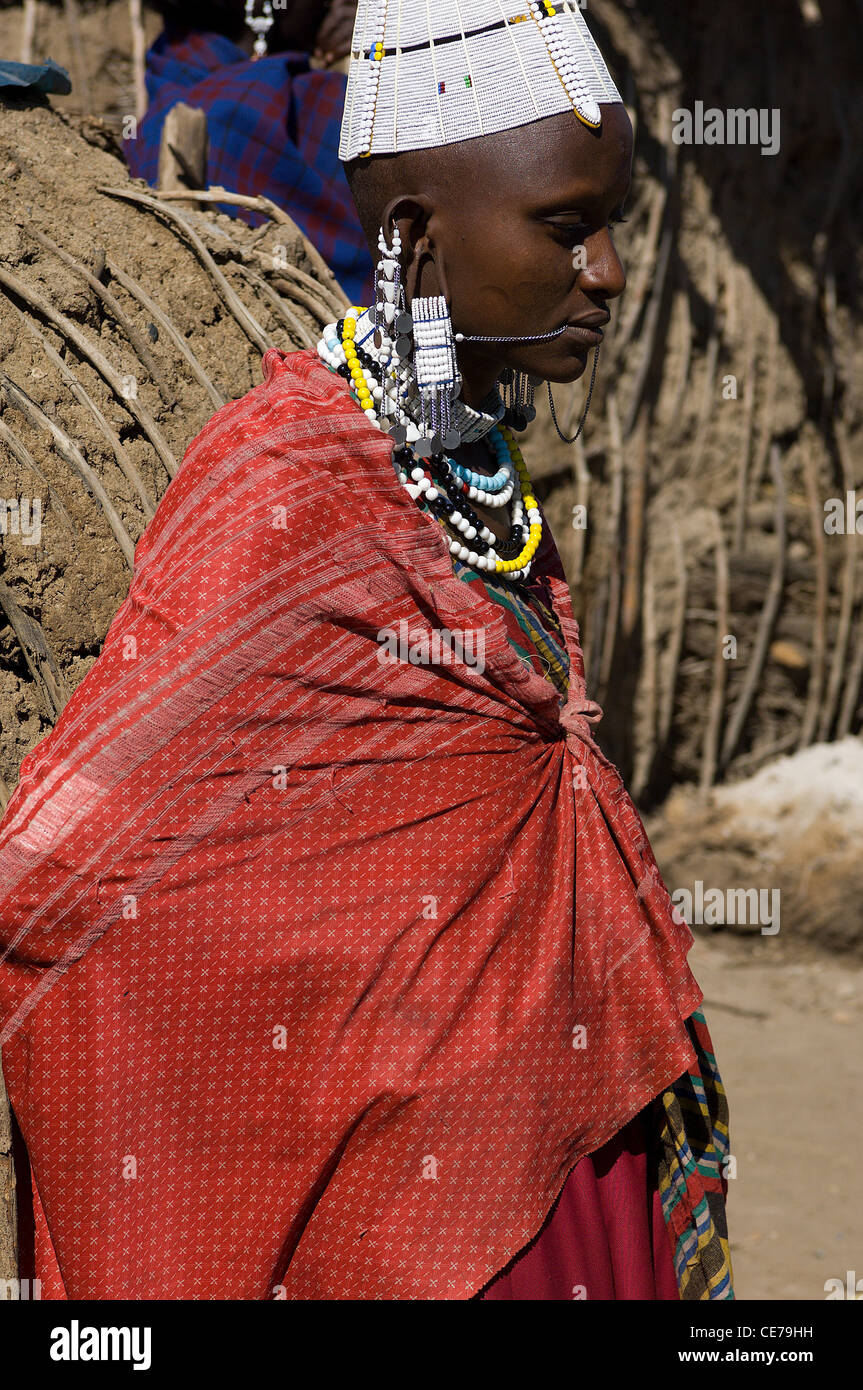 A Masai woman in Tanzania with the traditional shaved head and split ...
