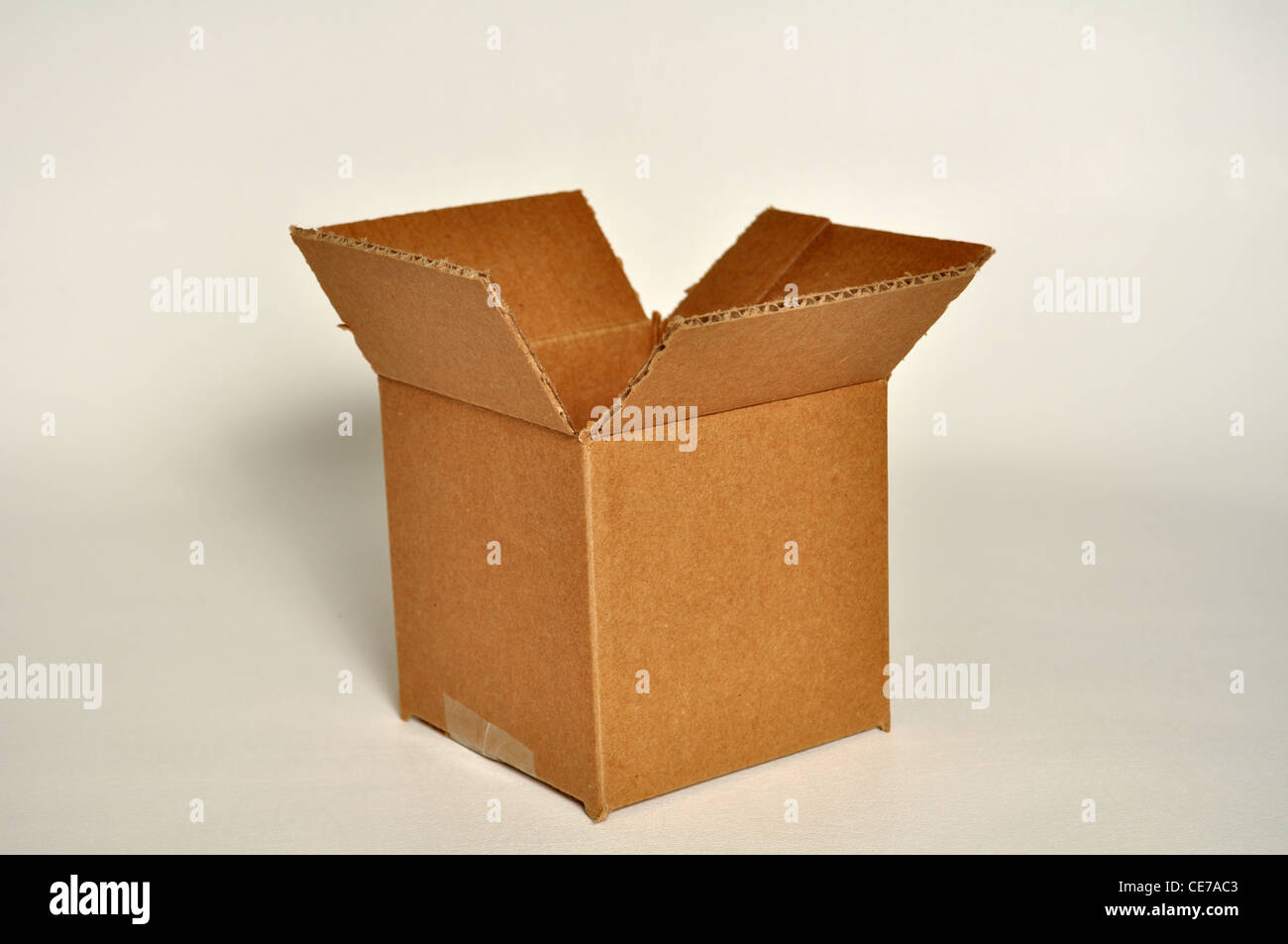 A empty cardboard box sits on a plain white background Stock Photo - Alamy