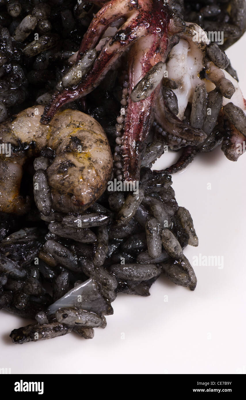 Arroz negro, traditional Spanish rice cooked with squid ink Stock Photo ...