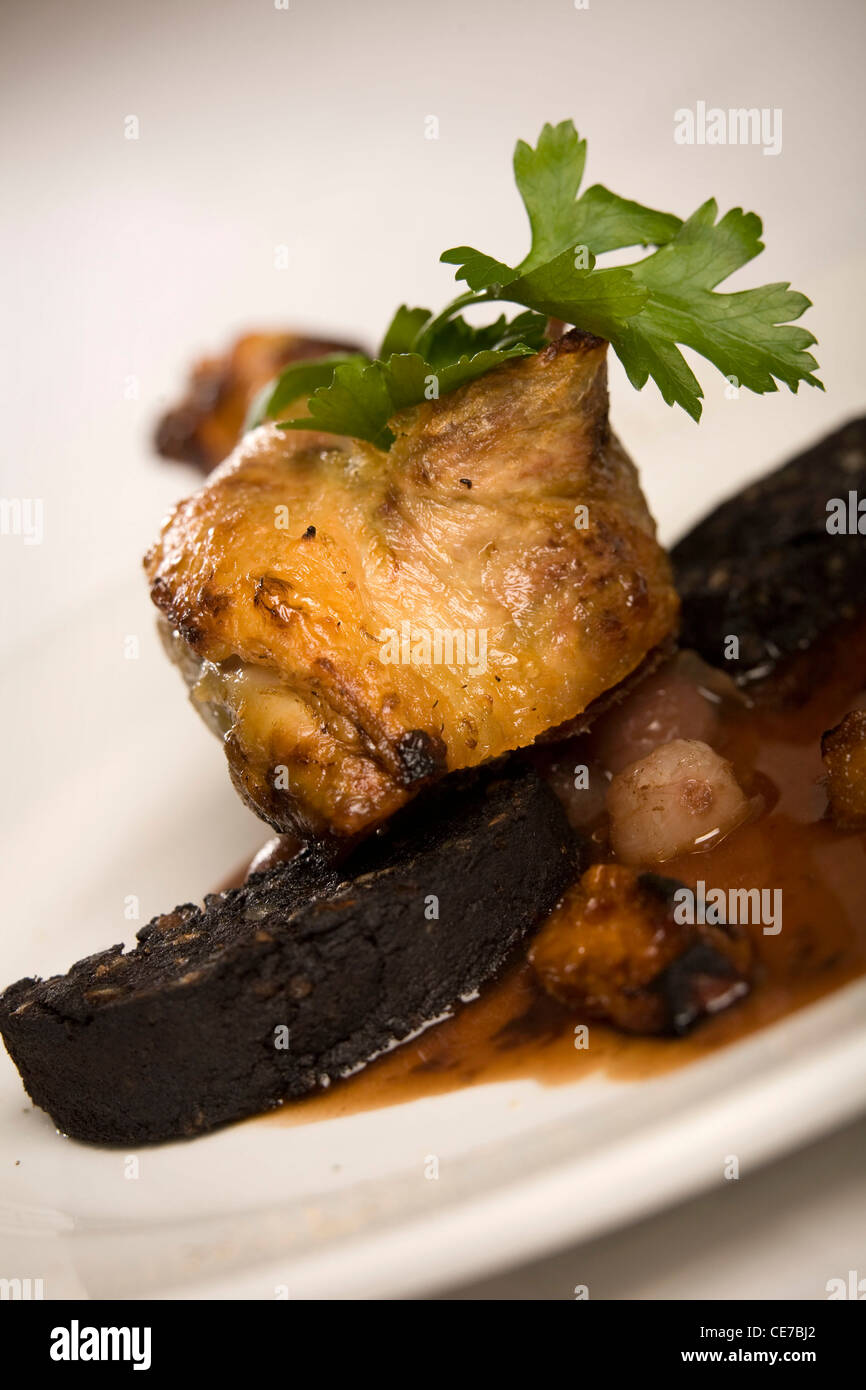 LEG OF DUCK AND BLACK PUDDING SERVED WITH APPLE AND PORK REDUCTION ...