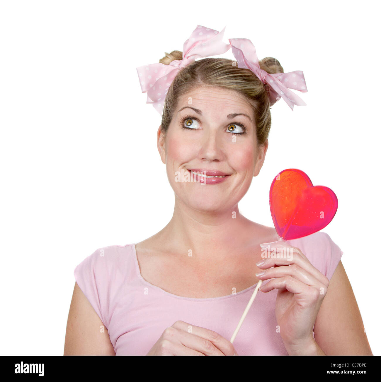 a funny or silly woman looking up smiling holding a valentines heart ...
