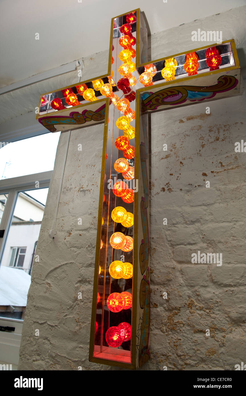 A Fairground crucifix with lights hangs from a wall. Picture by Pete ...