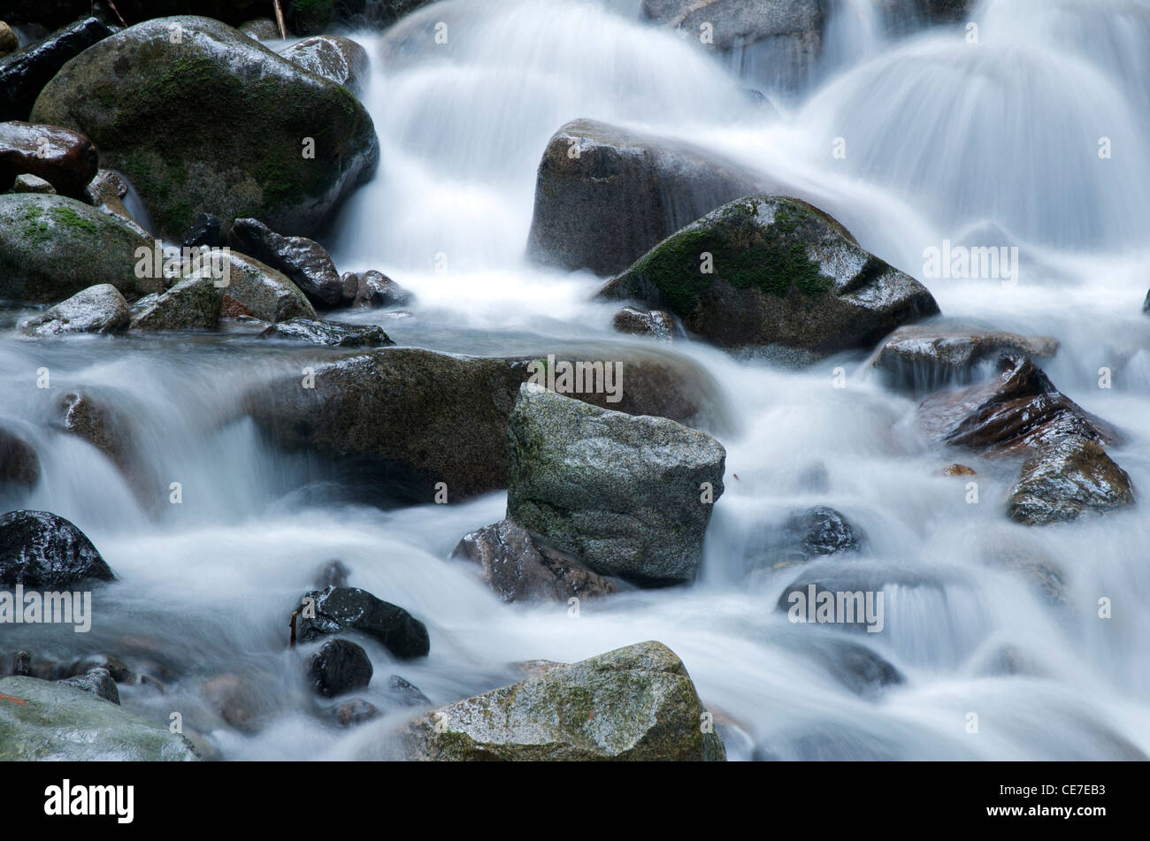 Waterfalls flow over river rocks, fresh mountain stream water shot on ...