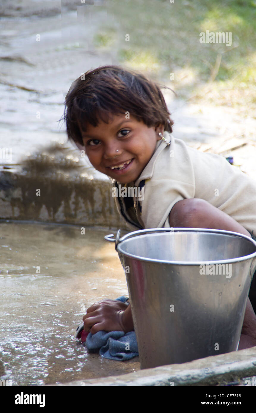 Indian girl washing clothes hi-res stock photography and images - Alamy