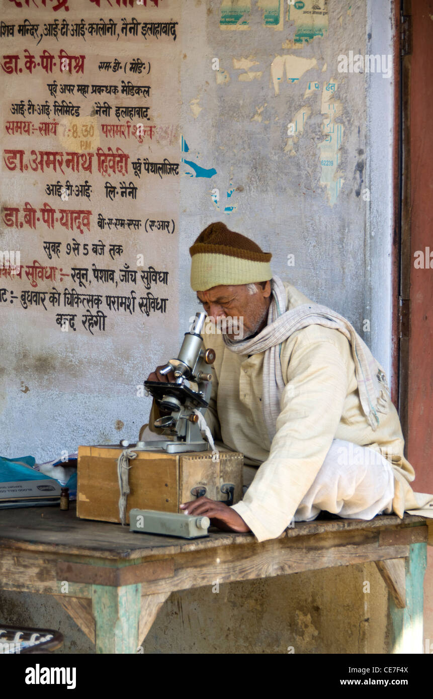 old Indian man looking through a microscope Stock Photo - Alamy
