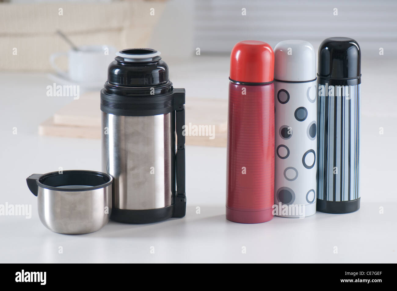 Set of vacuum flasks on a kitchen table Stock Photo - Alamy