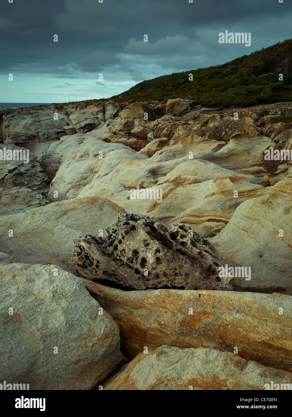 Eroded boulder in sandstone landscape, Booderee National Park, NSW ...