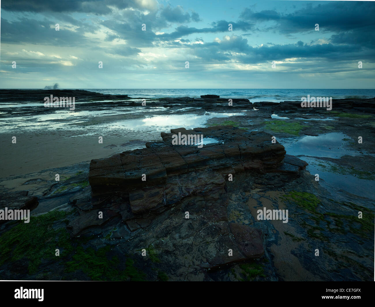 A pulpit of basalt and slate late afternoon as storm builds, Wombarra ...