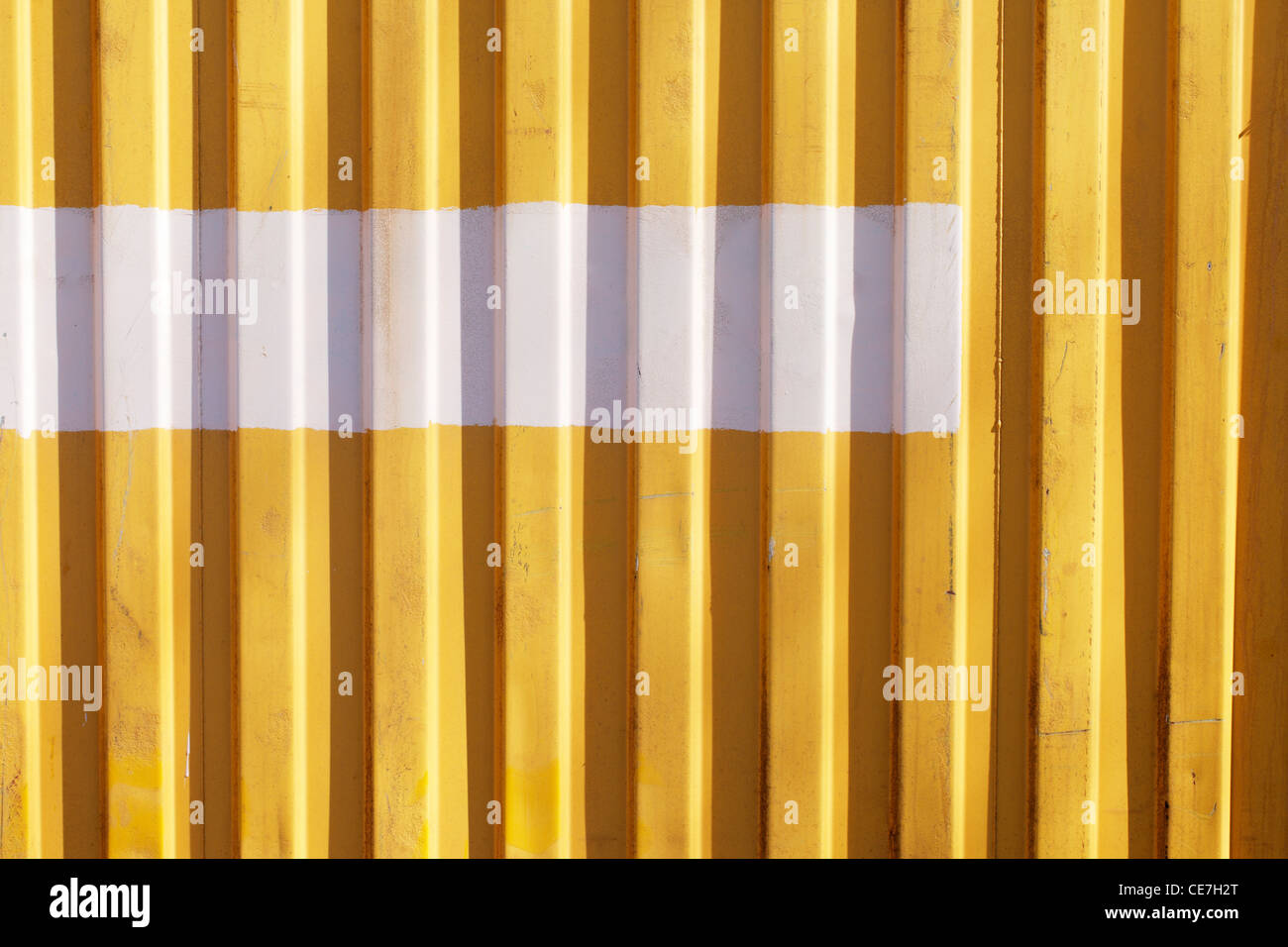 Detail of old yellow metallic cargo container with a partial white ...
