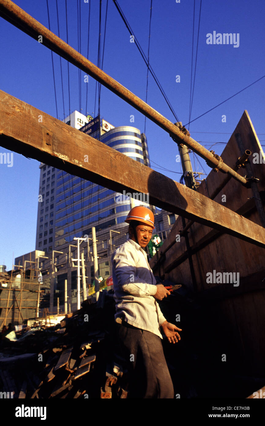 A Chinese worker in construction site in the city of Shanghai China ...