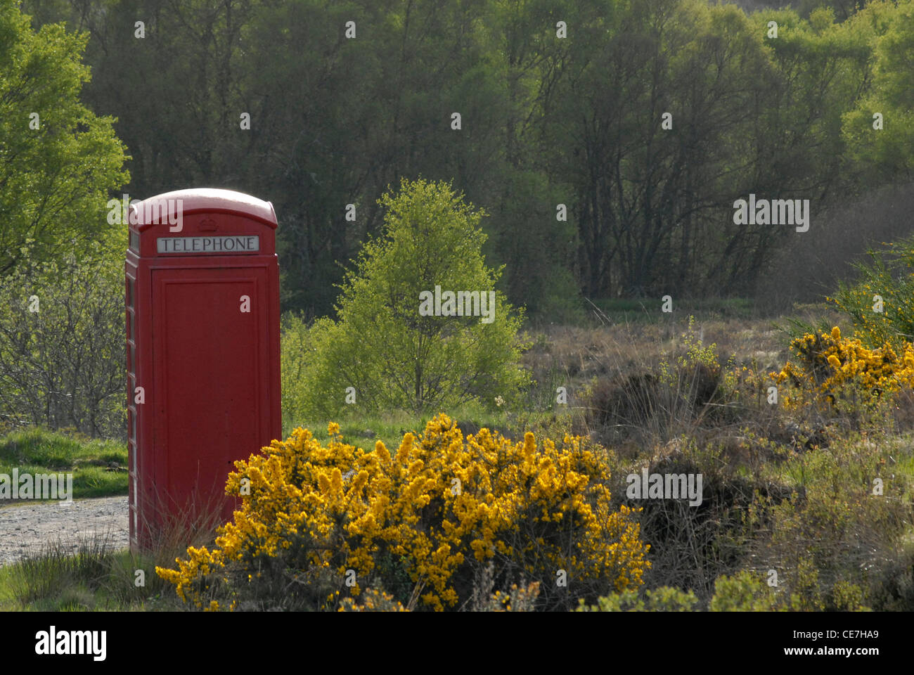 Old fashioned red telephone box in a countryside landscape, Sutherland ...