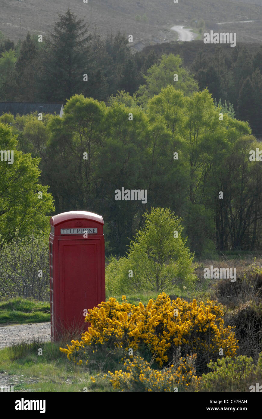 Old fashioned red telephone box in a countryside landscape, Sutherland ...