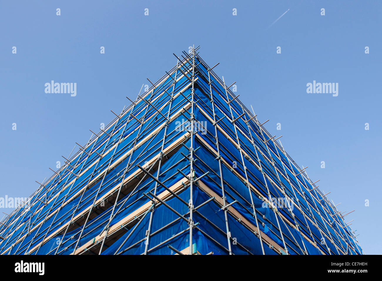 corner of blue scaffolding and blue sky with jet stream Stock Photo - Alamy
