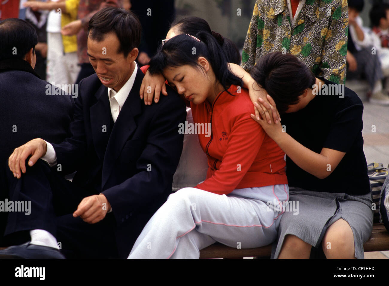 Chinese family rest in a bench in Wangfujing street in Beijing China ...