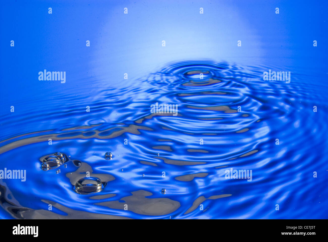 Water swirl and ripples in blue light Stock Photo - Alamy