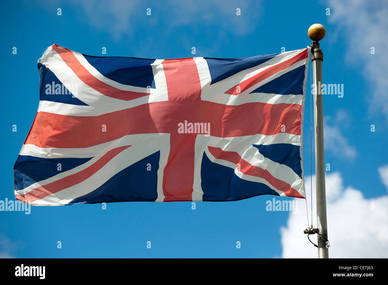 Union Jack fluttering on flagpole Stock Photo - Alamy