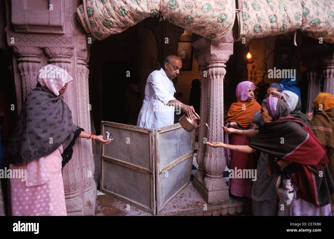 Hindu priest offering sacred water to the faithful ( India Stock Photo ...