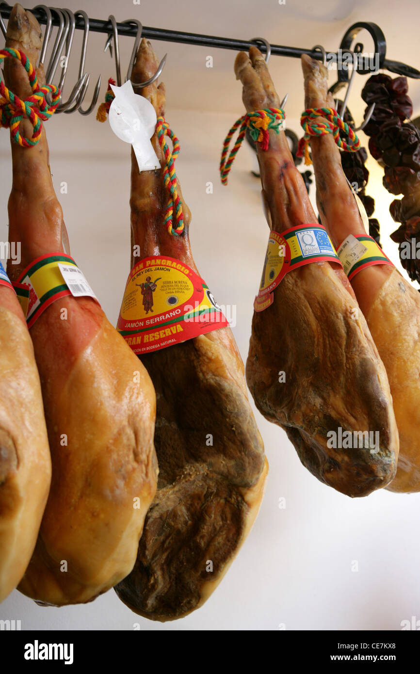Cured Spanish meats hanging on a rail in a charcuterie Stock Photo - Alamy