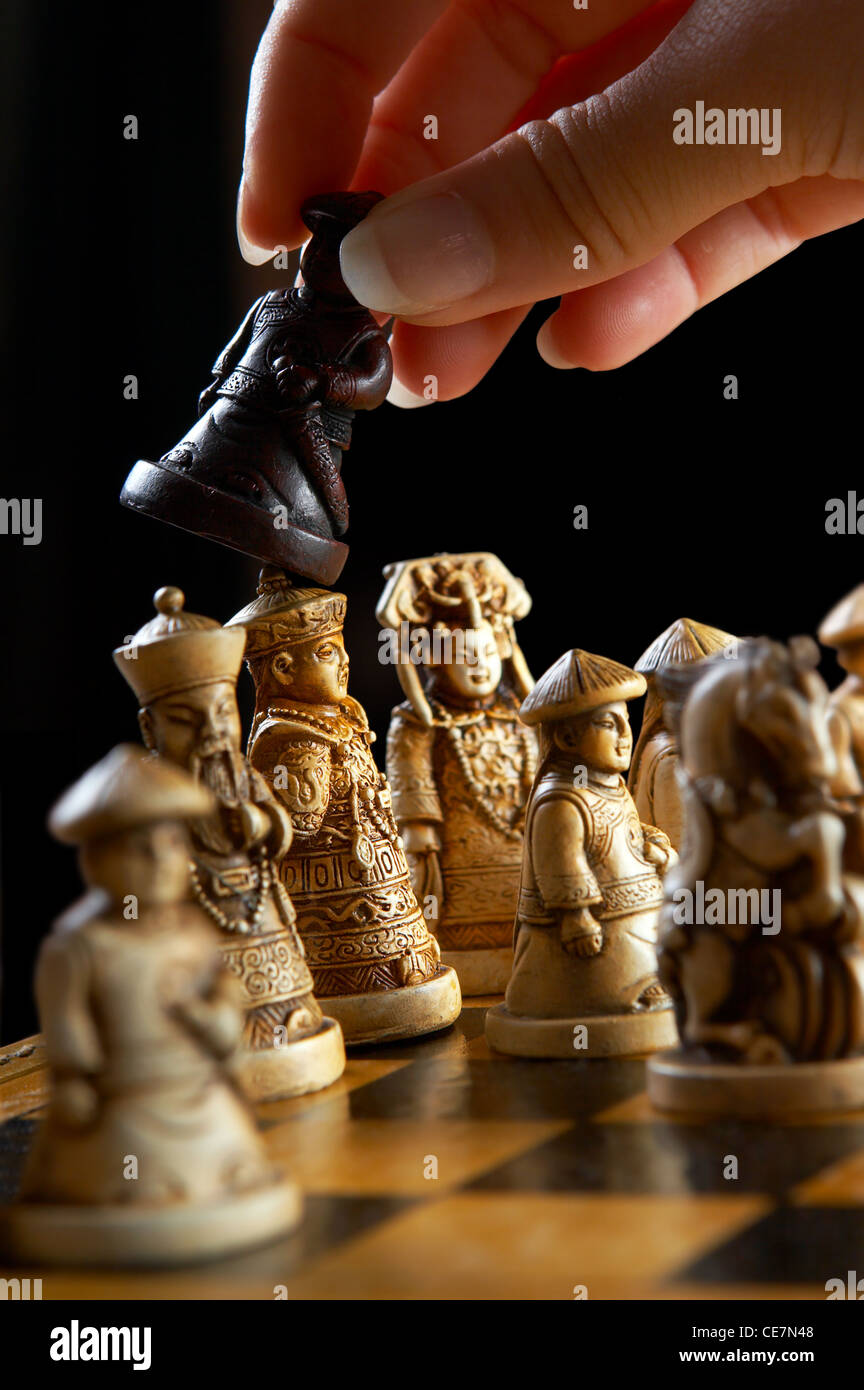 Hand playing chess with an antique chess set, view on the moment of ...