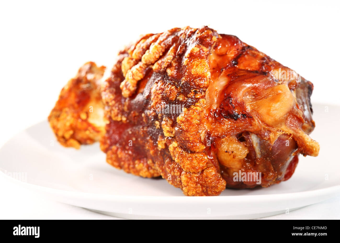 Grilled knuckle of pork on white background Stock Photo - Alamy